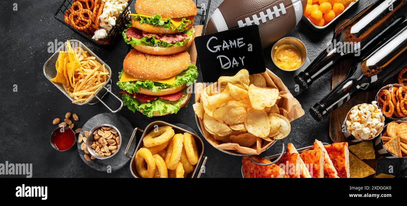 Selection of party food for watching football championship on a dark ...