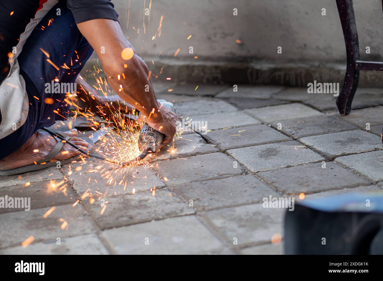 Craftsman using angle grinder kneeling on hi-res stock photography and ...