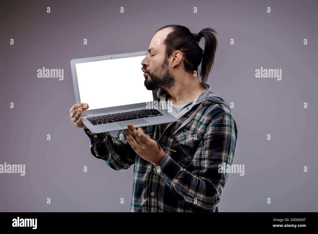 Passionate programmer kisses his laptop screen, showing love for coding ...