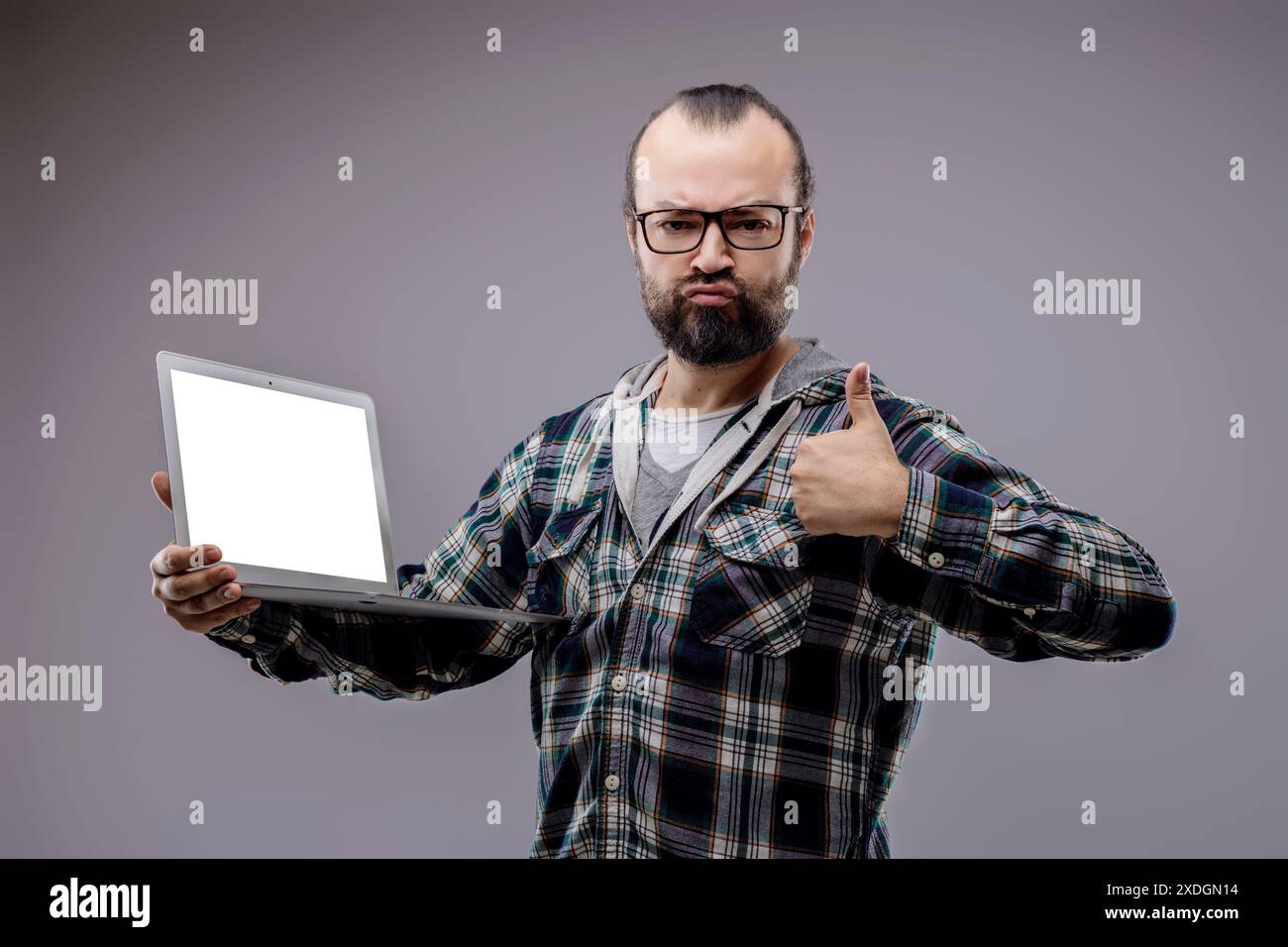 Web developer is holding a laptop with a blank screen and giving a ...