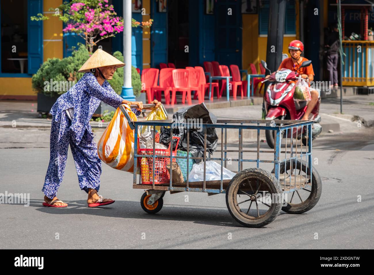 Vietnamese old woman pushing a cart with garbage bags. Hoi an, Vietnam ...