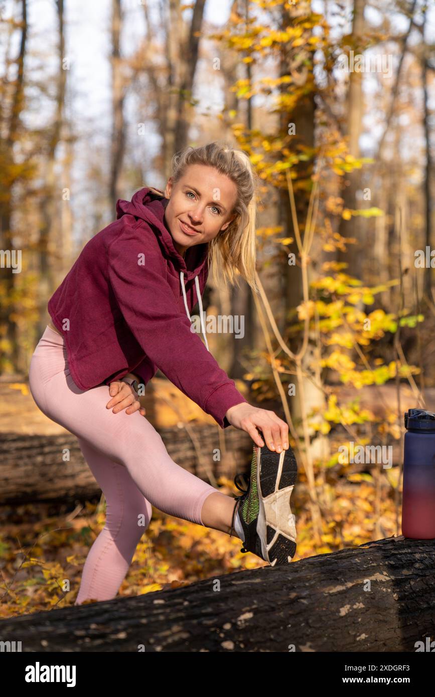 A young girl in a sports uniform. Sports. Jogging in the autumn park ...