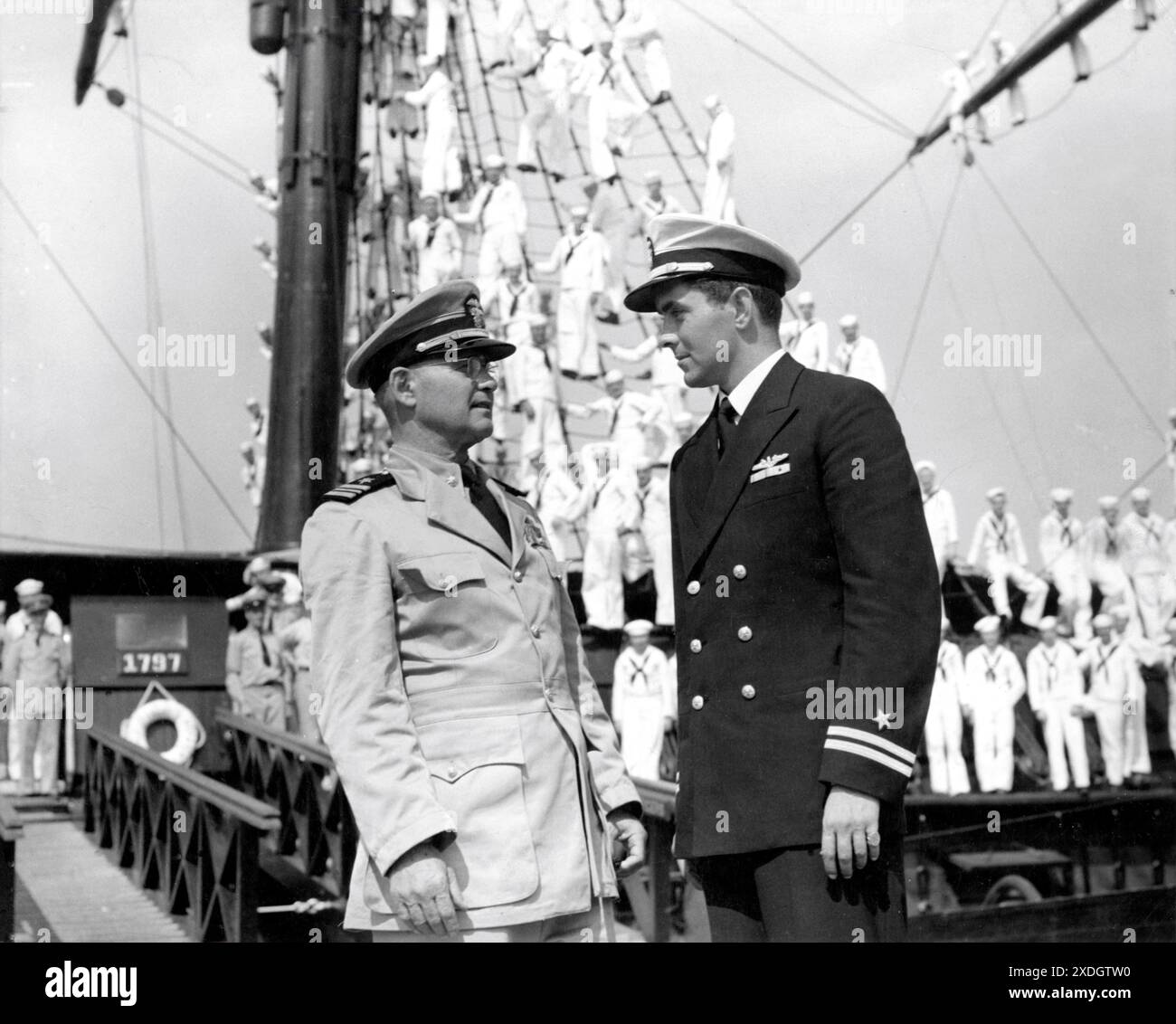 TYRONE POWER (right) with Lt. Commander JOHN DAVIS on set location ...