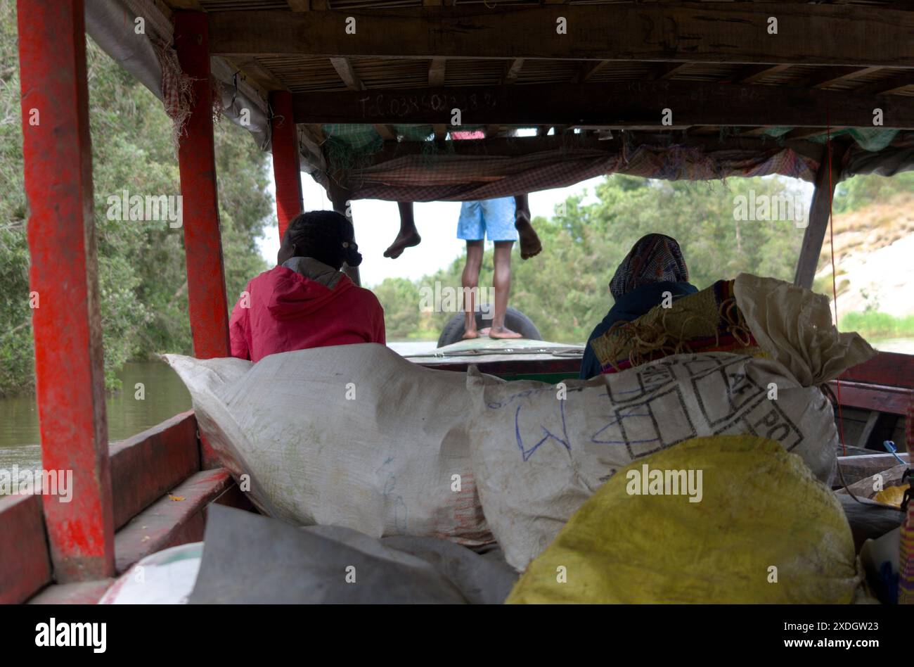 Merchandise river boat transporting bags of rice, flours and others ...