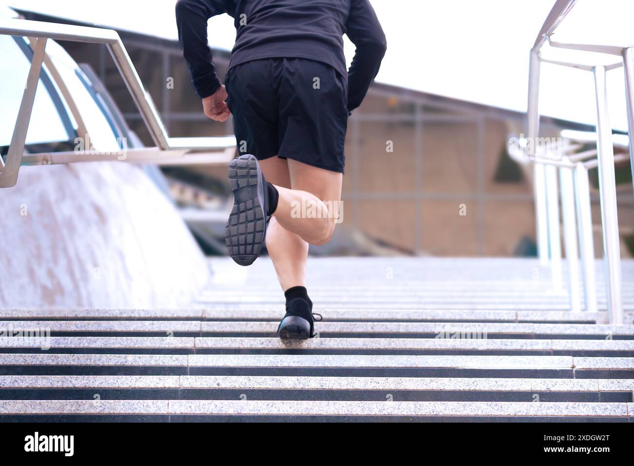 Athlete, running down the stairs, doing dynamic exercise outdoors Stock ...