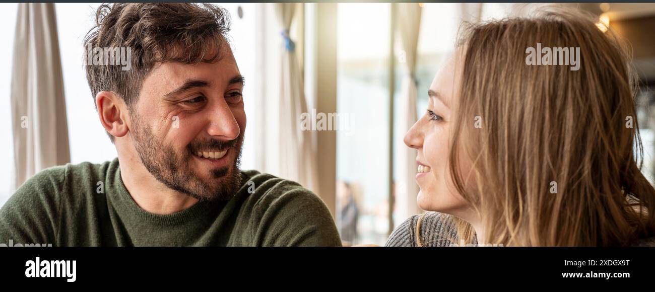 Smiling couple having a warm and intimate conversation at a bar. They ...