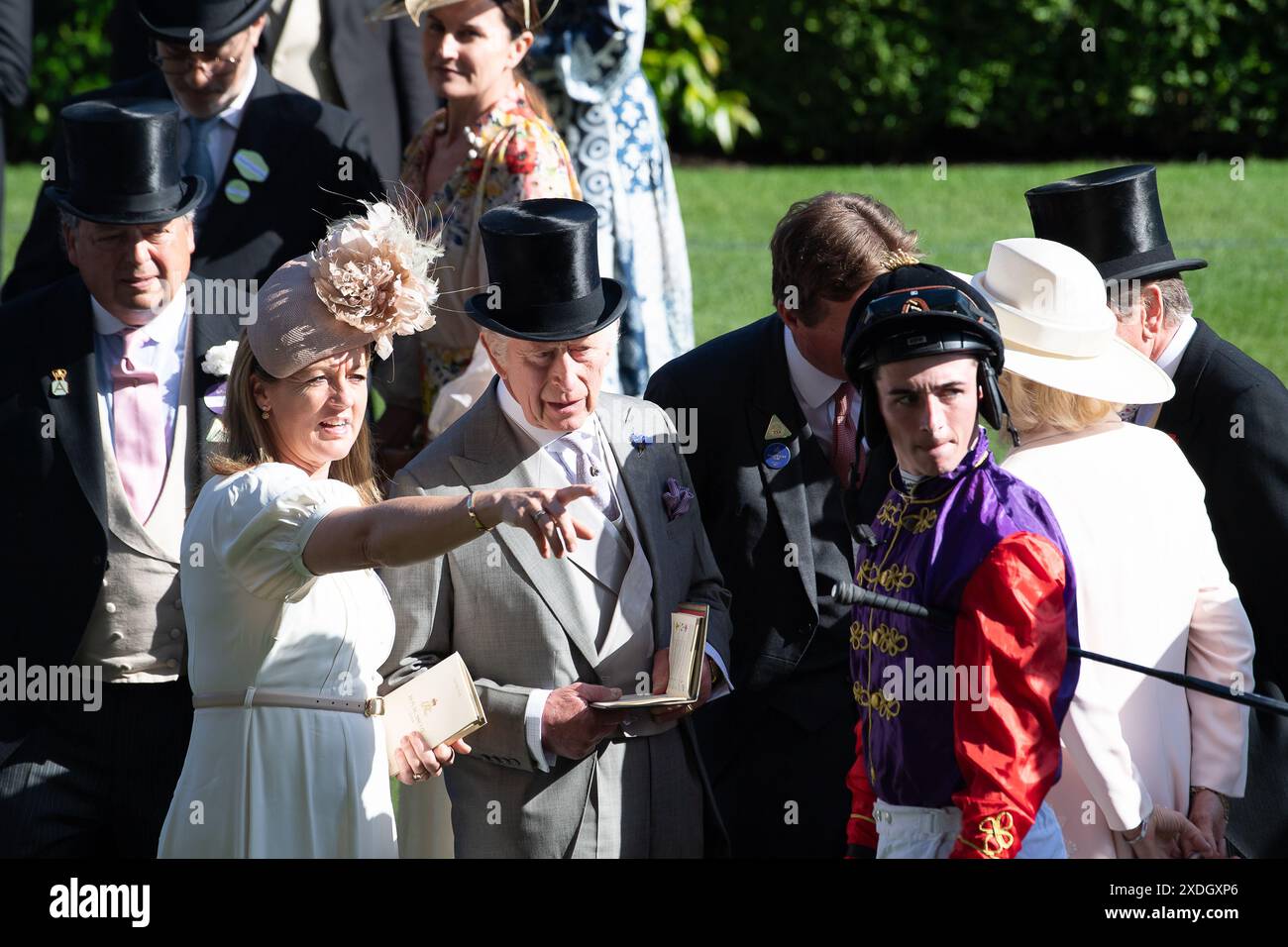 Ascot, UK. 22nd June, 2024. The King and Queen Camilla chat to trainer ...