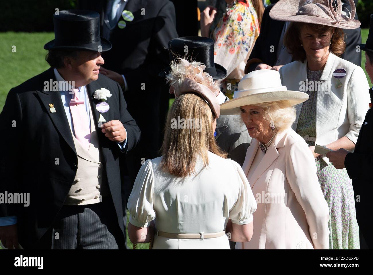 Ascot, UK. 22nd June, 2024. The King and Queen Camilla chat to trainer ...