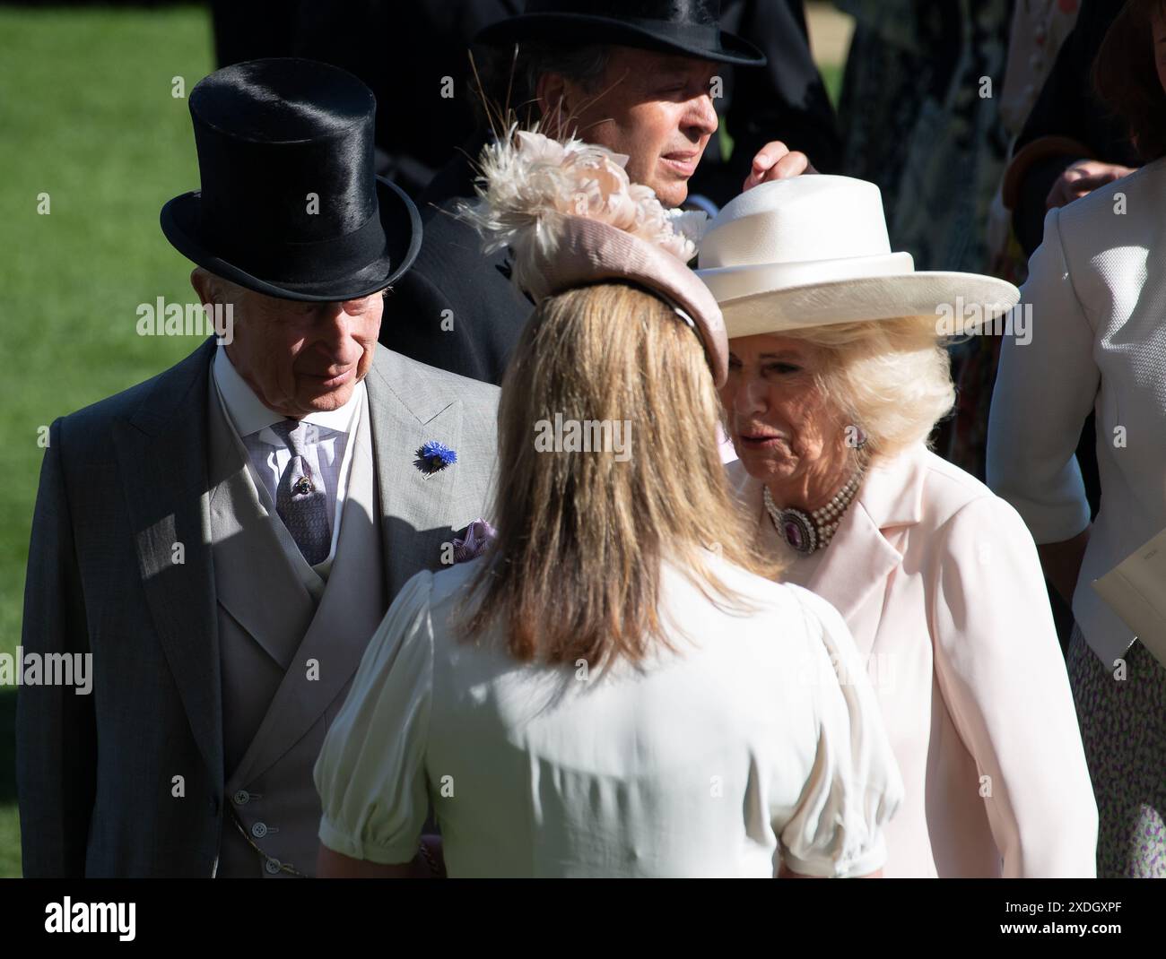 Ascot, UK. 22nd June, 2024. The King and Queen Camilla chat to trainer ...