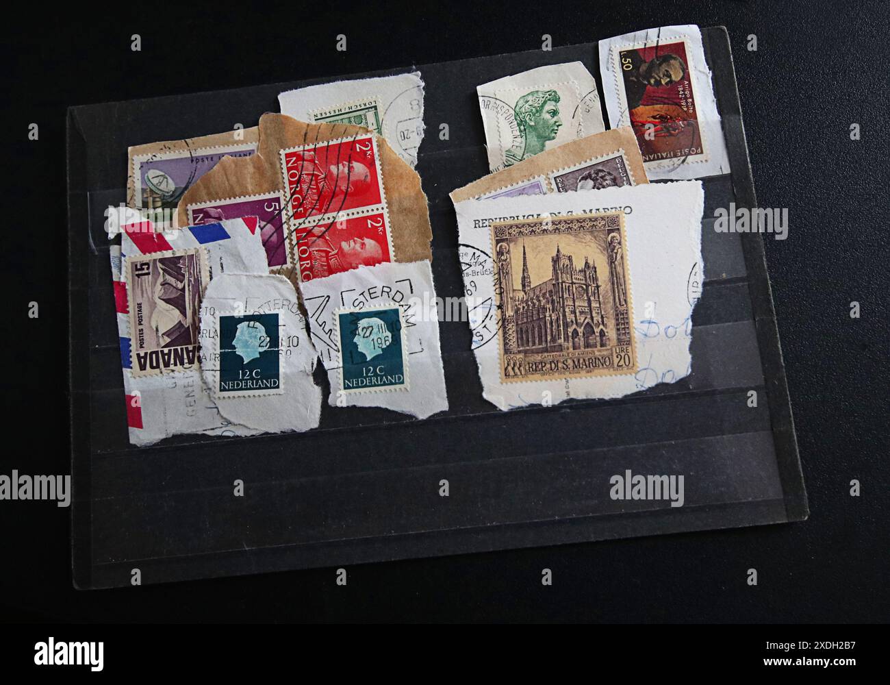 Philately collection: assorted used postage stamps cut from letters or ...