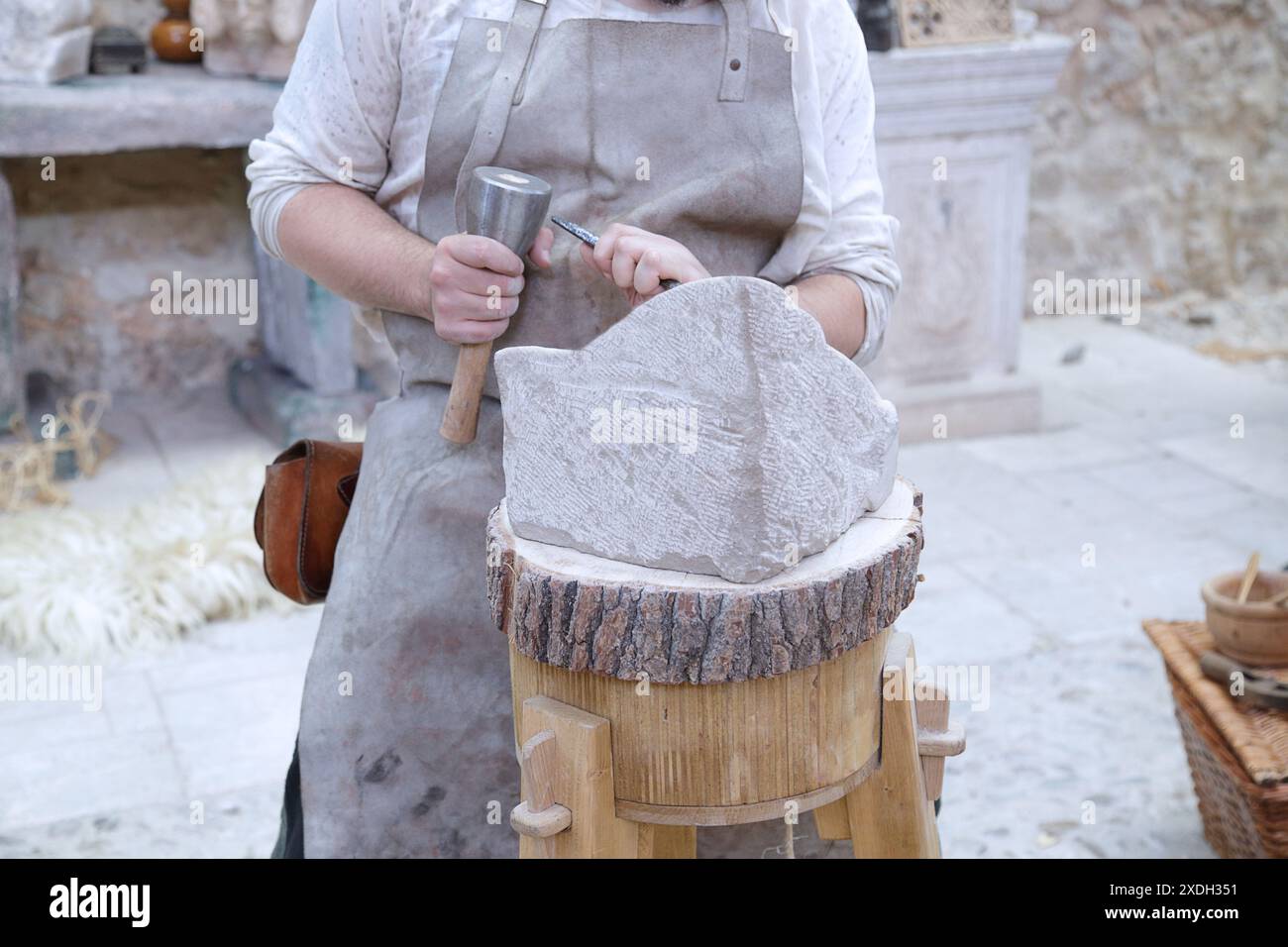 Close up of young sculptor hands working on his marble sculpture in his ...