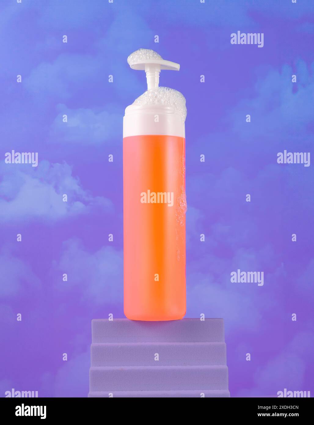 Trendy orange soap shampoo, lotion mockup bottle with foam, bright blue ...