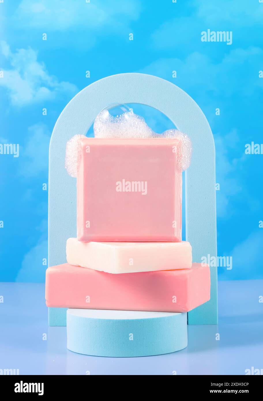 Trendy pink pastel soap bar with foam in a modern setting, blue sky ...
