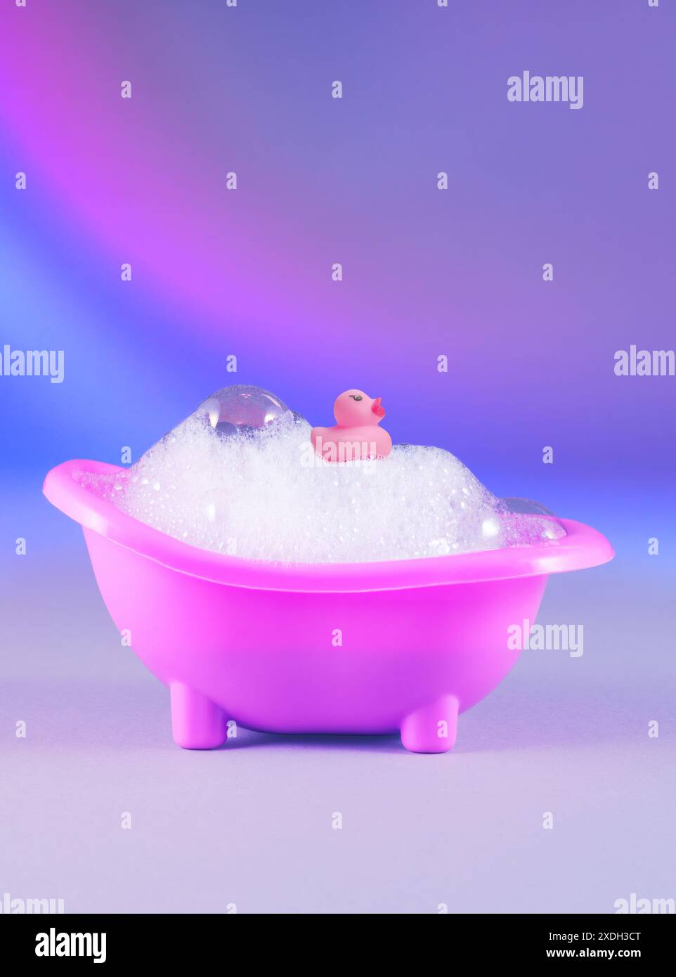 Cute pink duck in foamy pink tub, vibrant gradient backdrop Stock Photo ...
