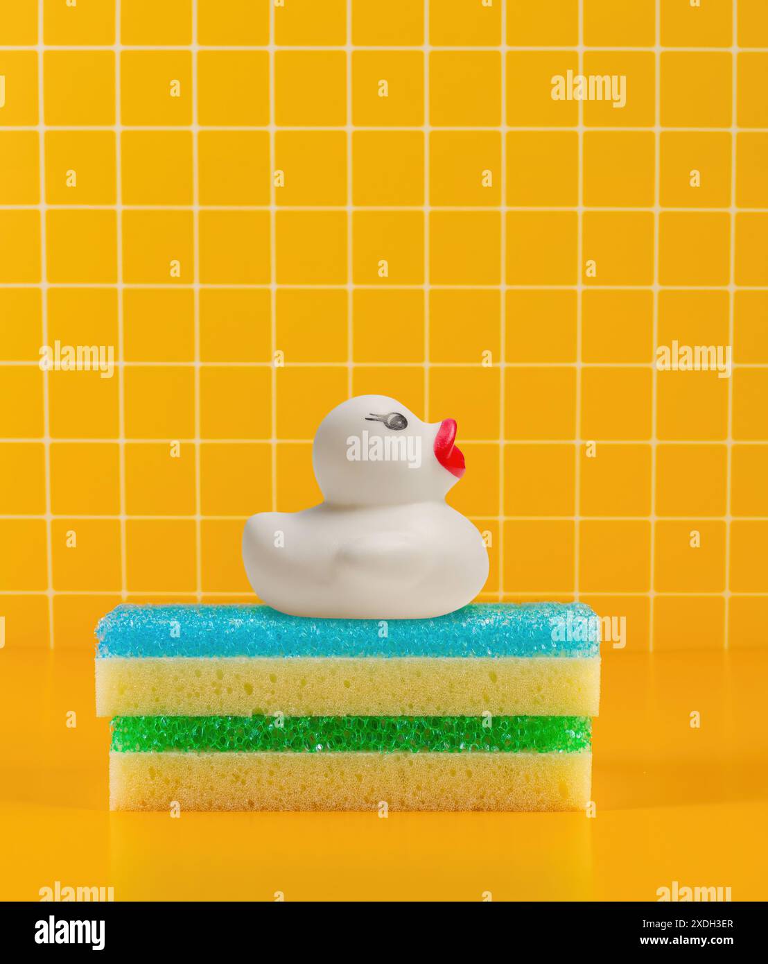 Fashionable white duck with red beak on multicolored sponges, yellow ...