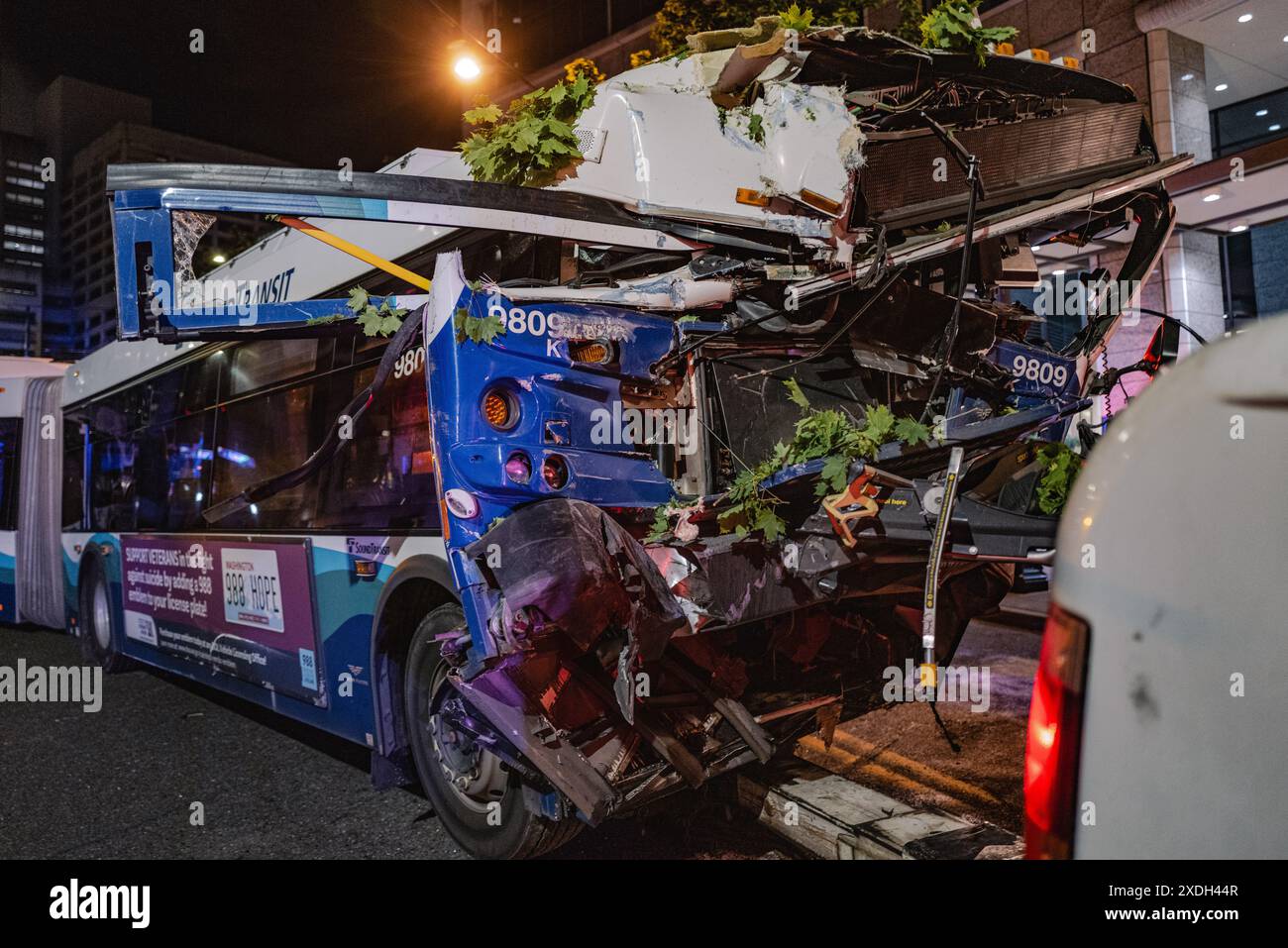 The front end of a Sound Transit bus is seen crumpled against a ...
