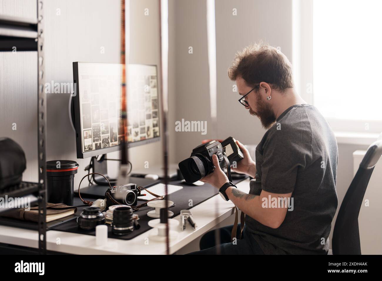 Professional photographer inspecting a medium format camera Stock Photo ...