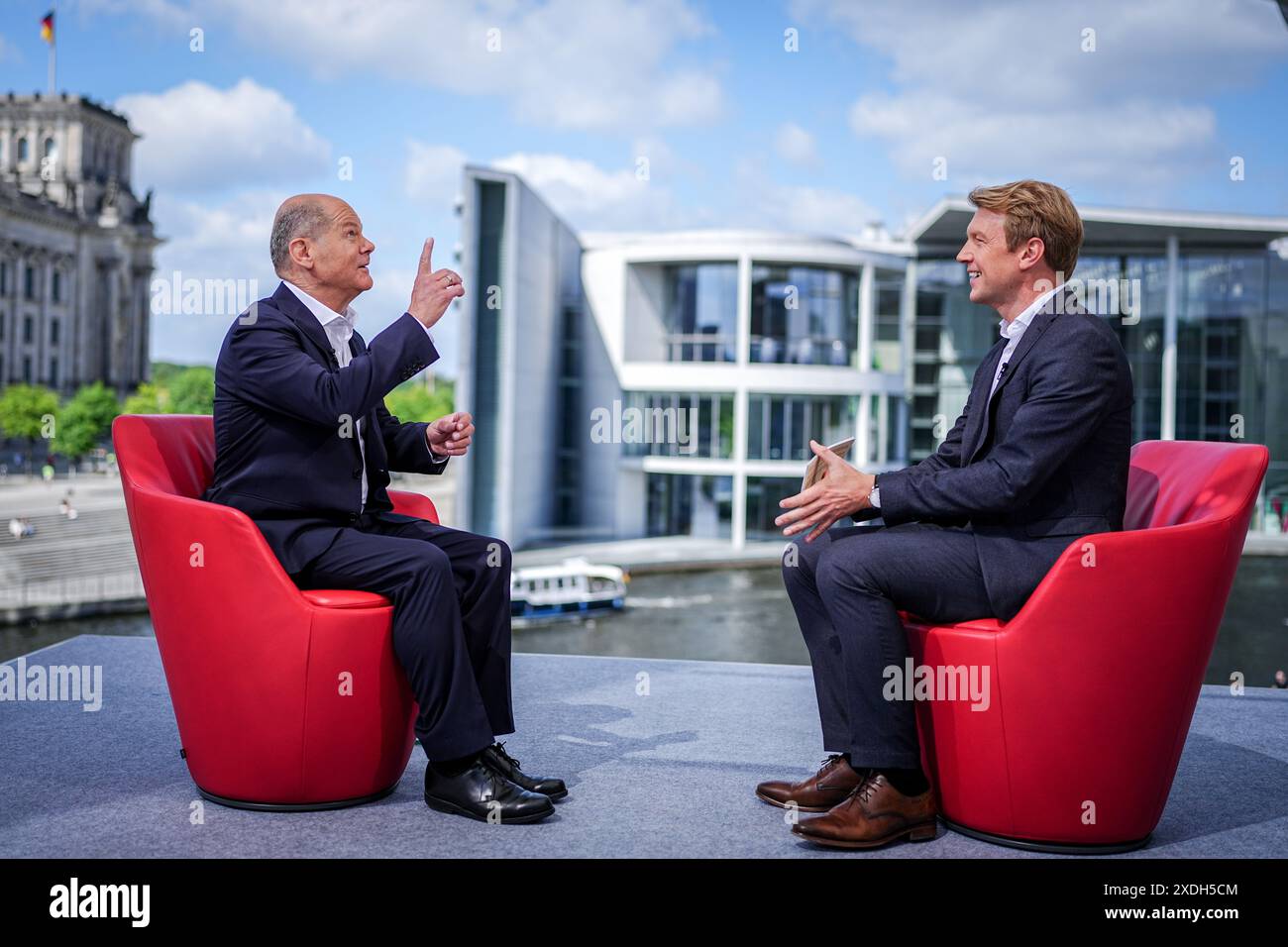 23 June 2024, Berlin: Federal Chancellor Olaf Scholz (SPD) sits with ...