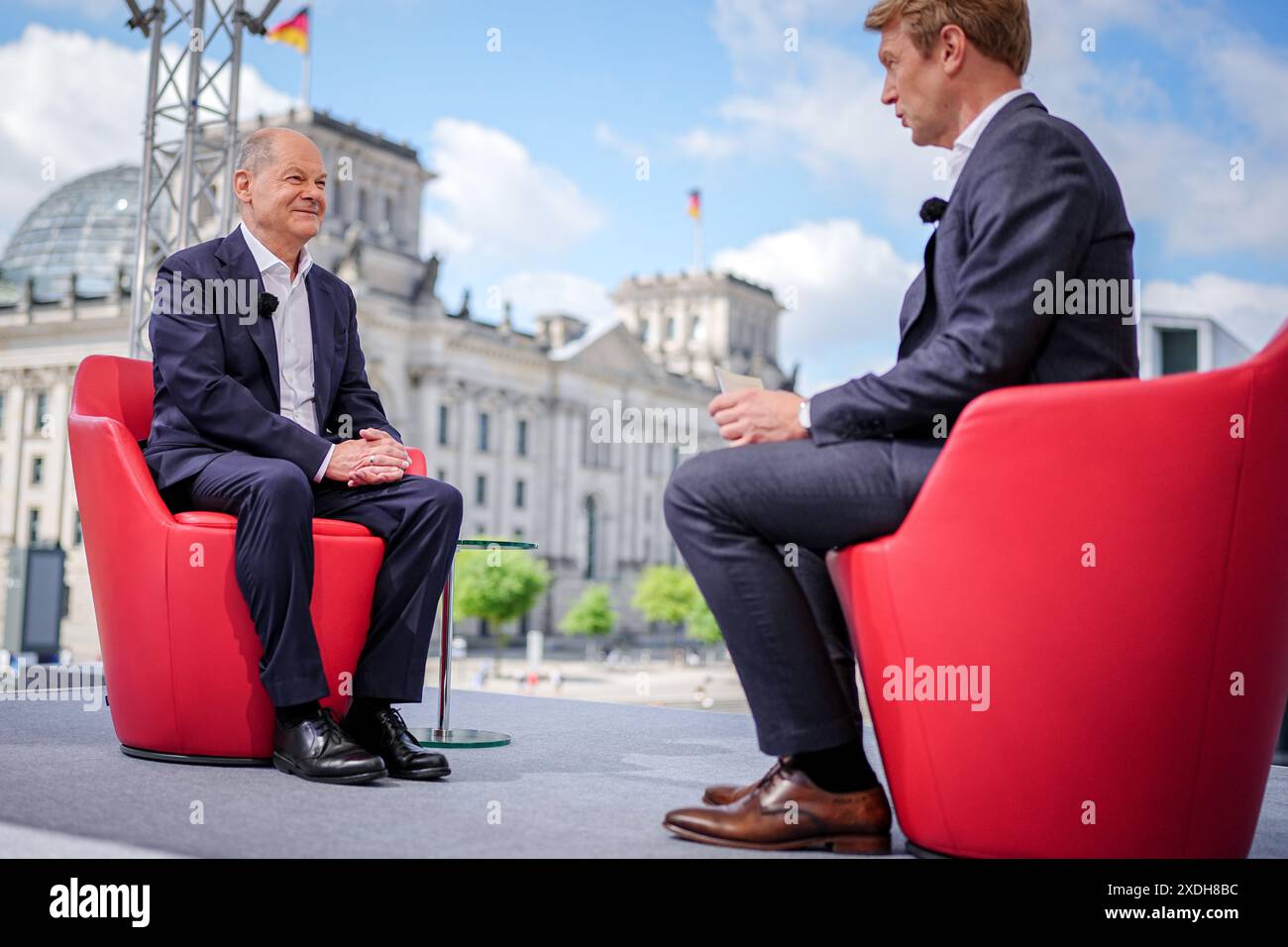 23 June 2024, Berlin: Federal Chancellor Olaf Scholz (SPD) sits with ...