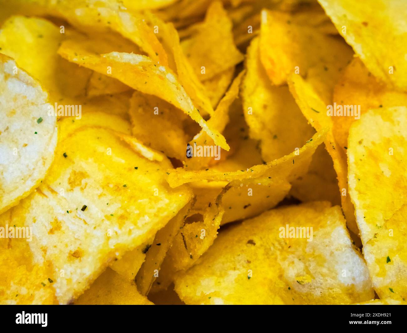 Seasoned Chips Pile. A heap of golden potato chips, seasoned with herbs ...