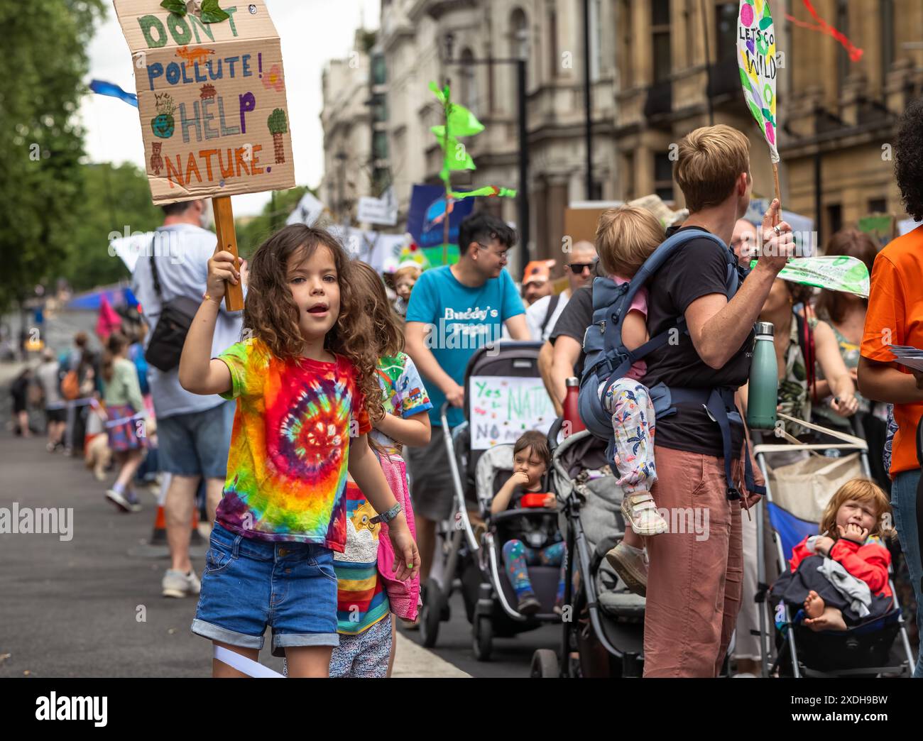 London UK - Jun 22 2024: A young girl carries a placard reading "Don't ...