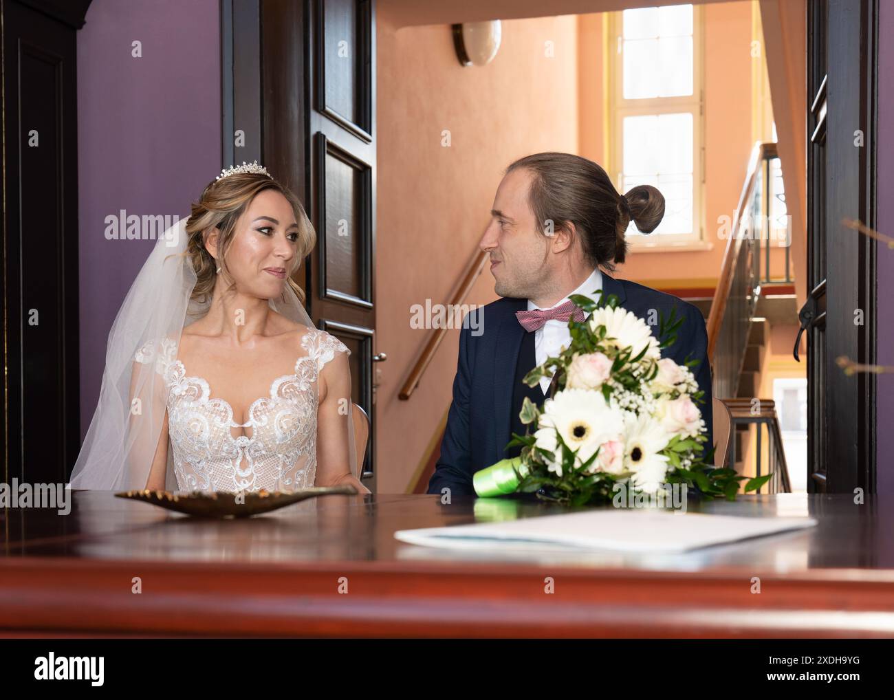 Marriage. Young bride and groom in a white wedding dress and blue suit ...