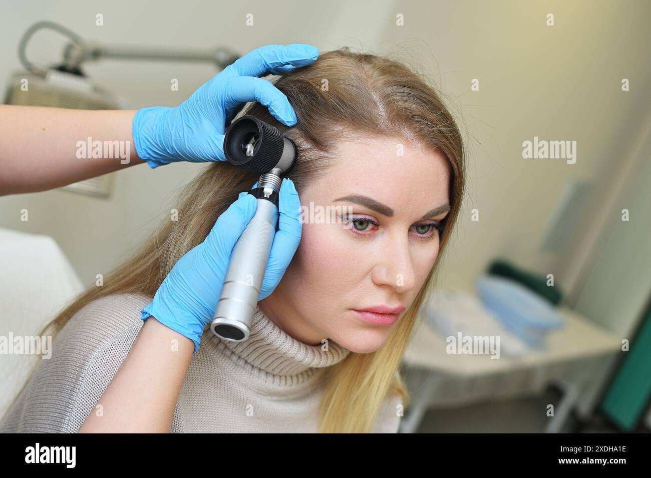 dermatologist trichologist examines the hair structure of a young woman ...