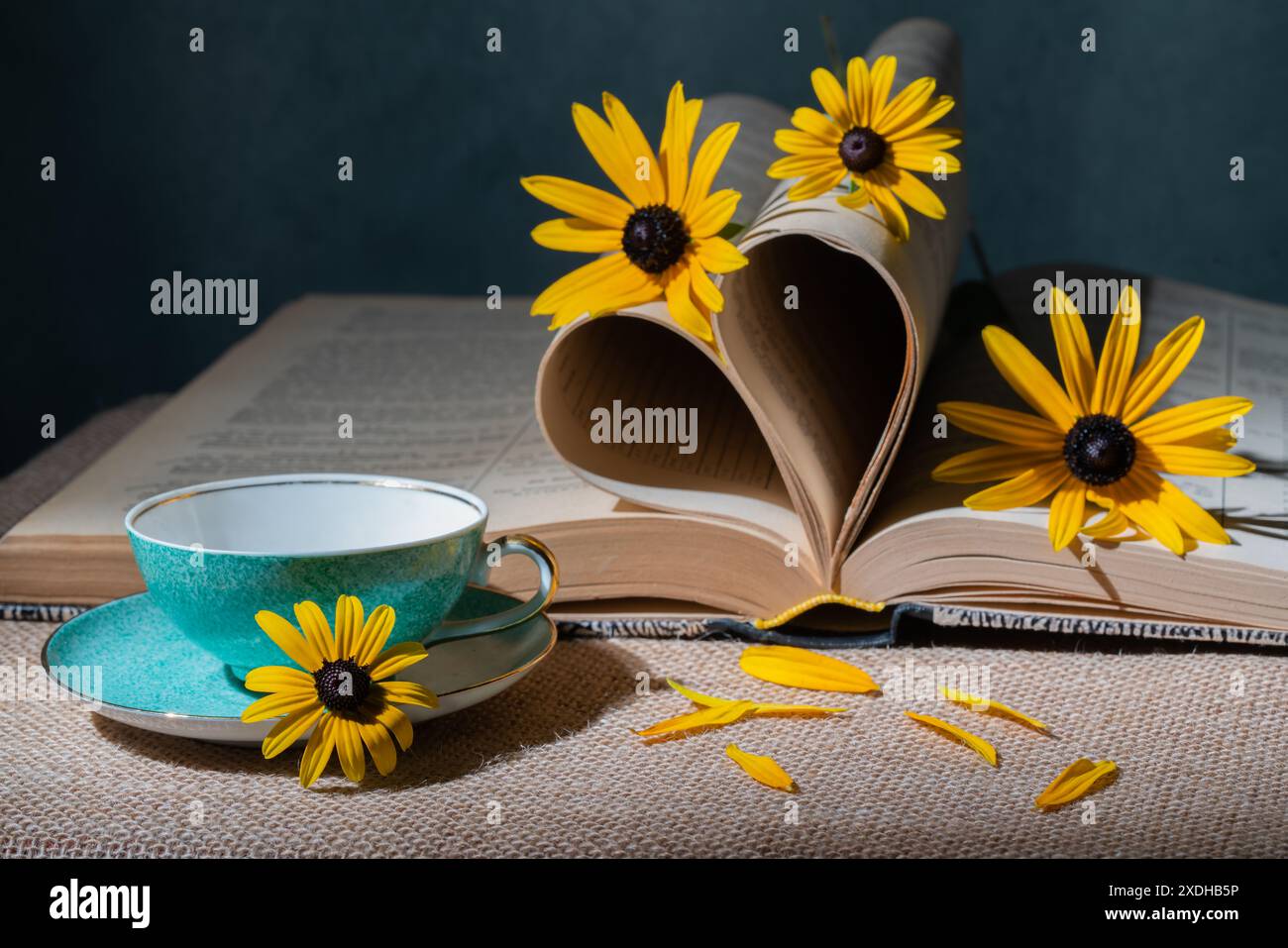 Open book with flowers and a cup of tea on the table Stock Photo - Alamy