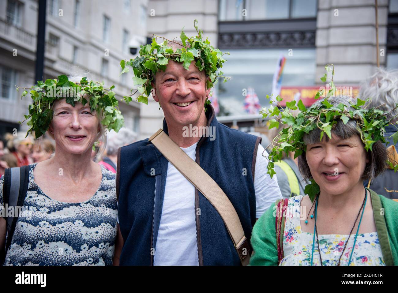 London, UK. 22nd June, 2024. Activists pose adorned with greenery on ...