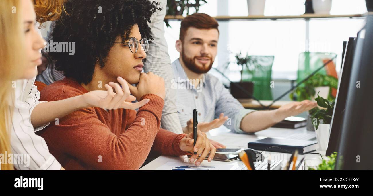 Millennial team working with new project on computer screen Stock Photo ...