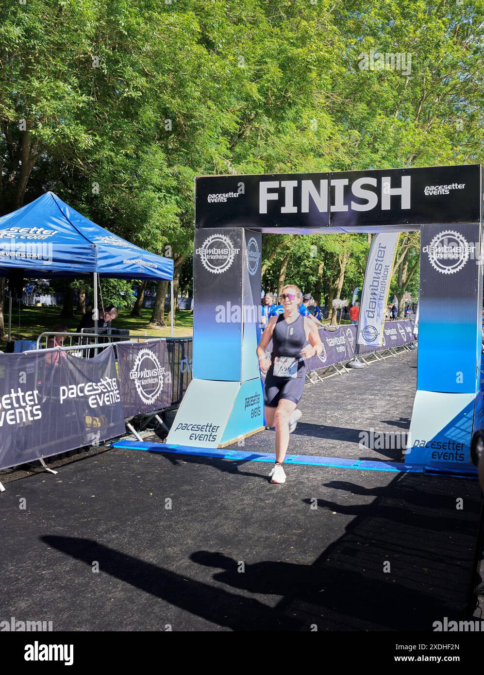 Competitor crosses the finish line during the Dambuster triathlon race ...