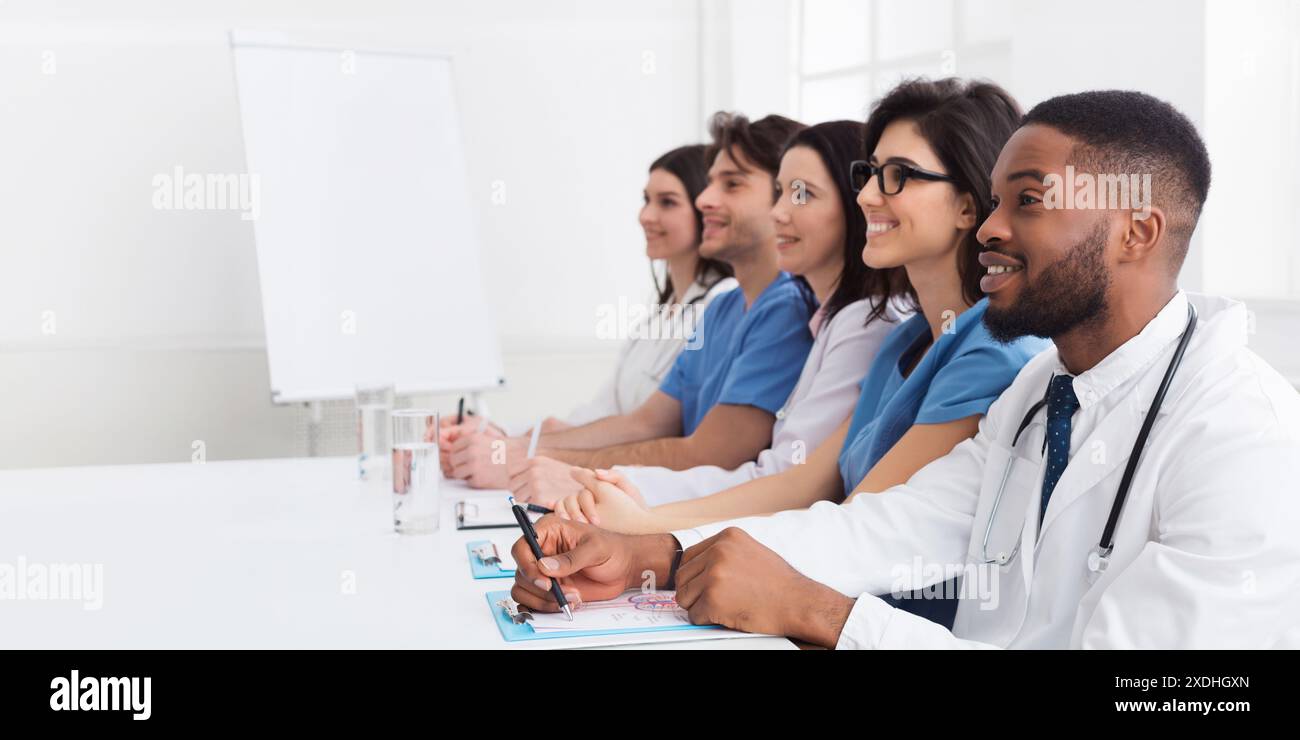 Medical lecture. Doctors and interns listening to professor Stock Photo ...