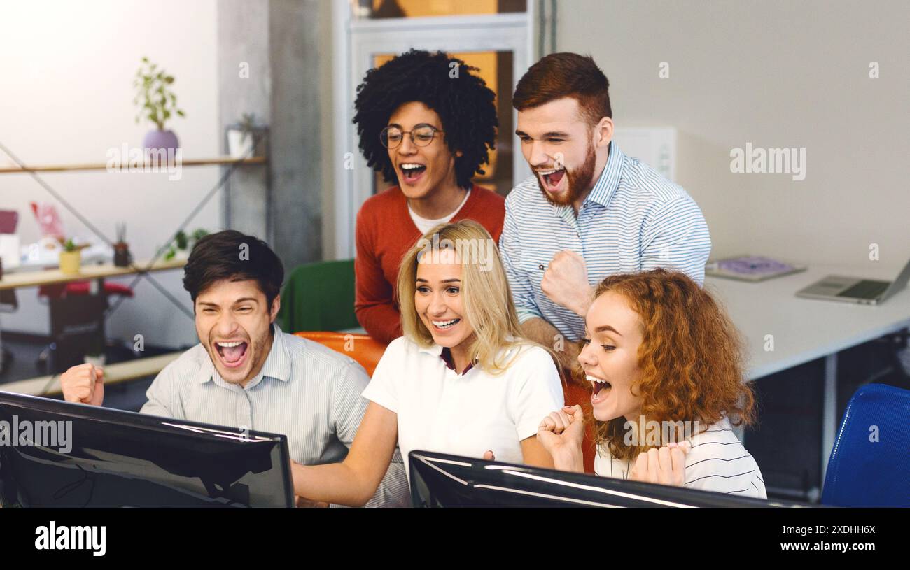 Business team looking at screen of computer celebrating victory Stock ...