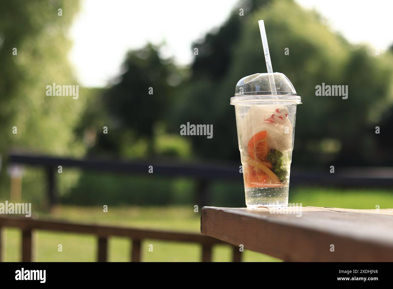 Plastic disposable cup with trash inside, close-up. Improper disposal ...