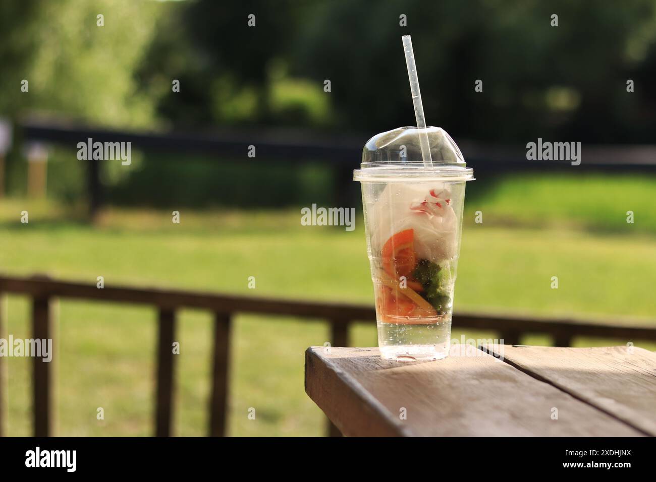 Plastic disposable cup with trash inside, close-up. Improper disposal ...