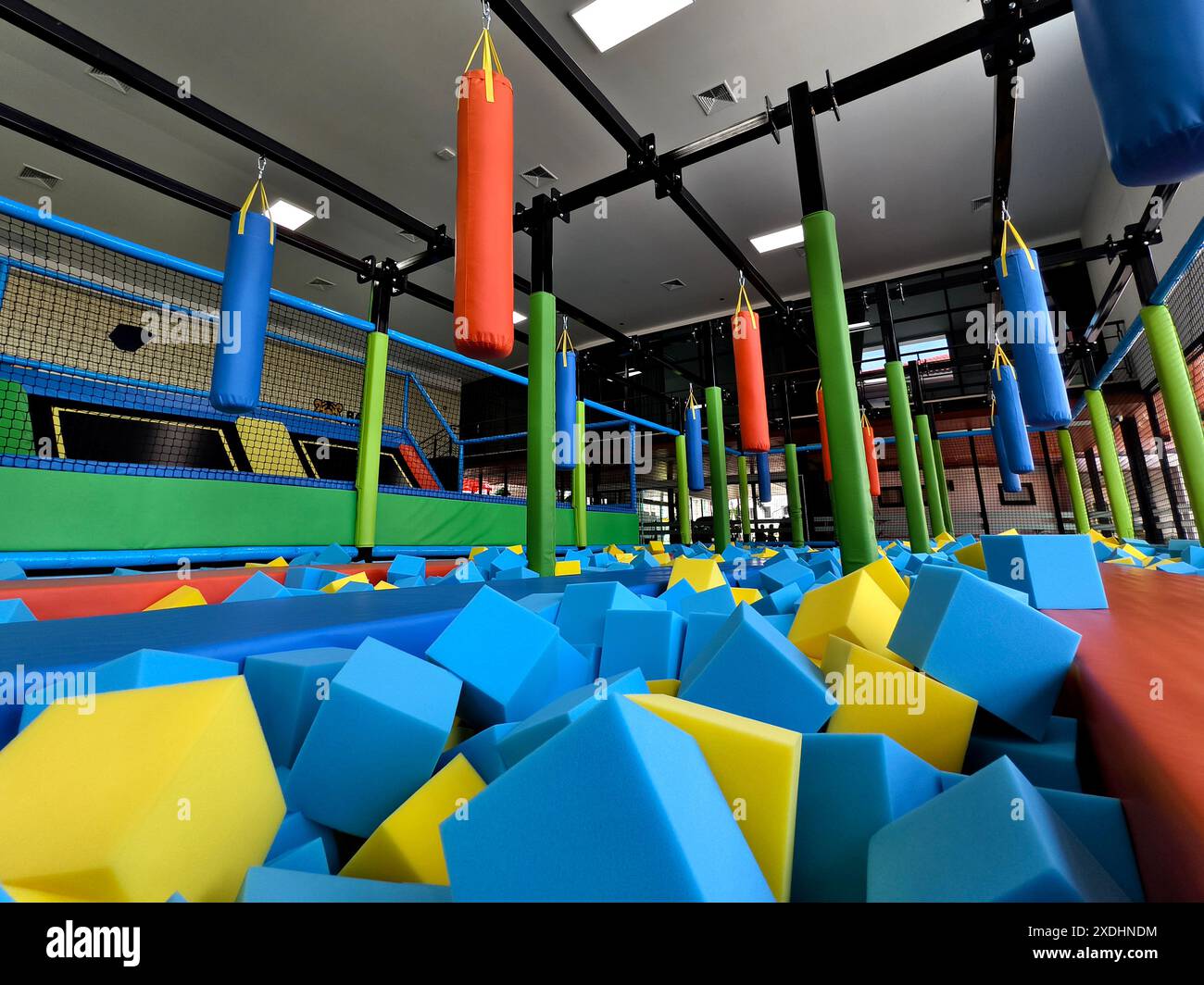 Trampoline park has blue and yellow foam cubes for kids fun Stock Photo ...