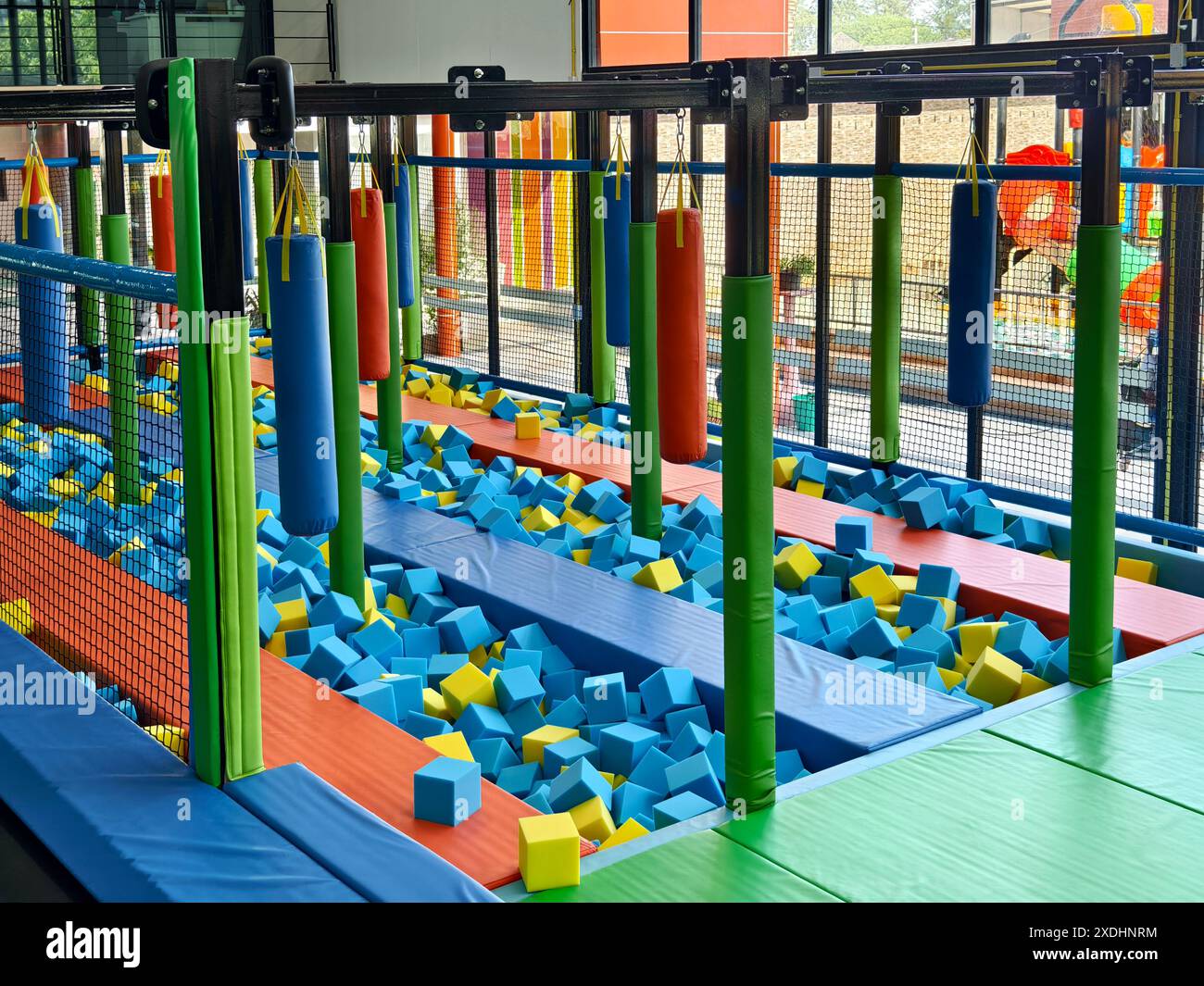 Trampoline park has blue and yellow foam cubes for kids fun Stock Photo ...