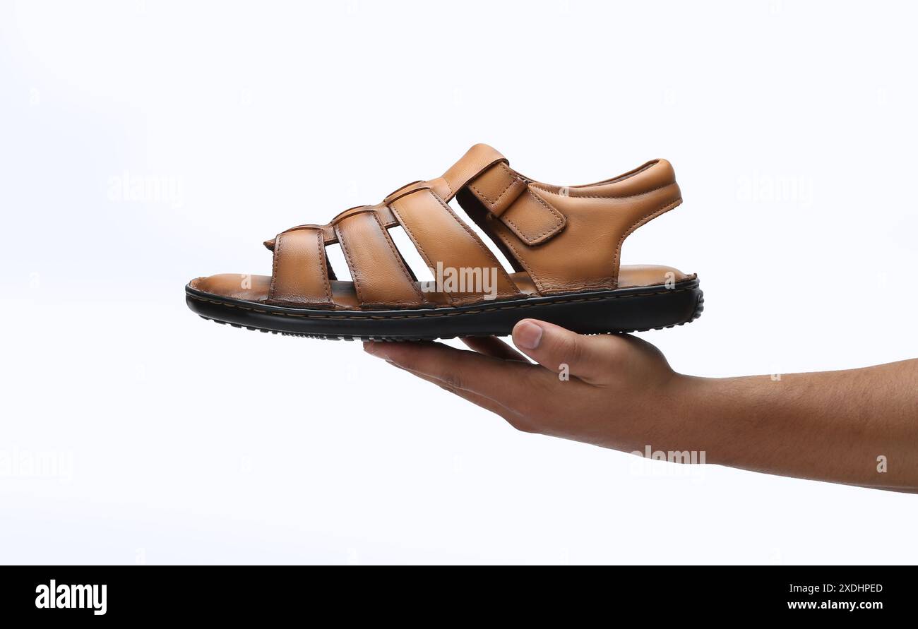 mens leather sandals hold in the hand isolated on white background ...