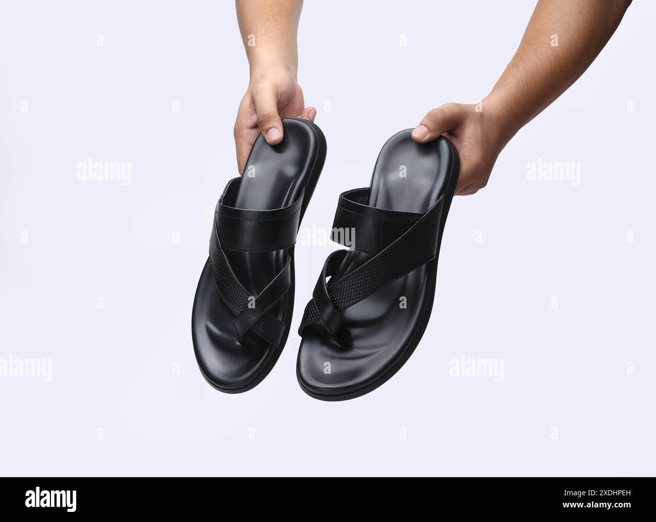 mens leather sandals hold in the hand isolated on white background ...