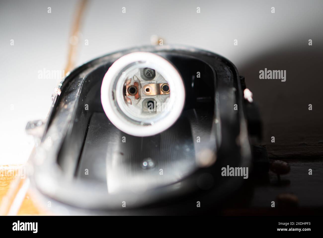 Close-up of an empty light bulb socket with visible wiring inside a ...