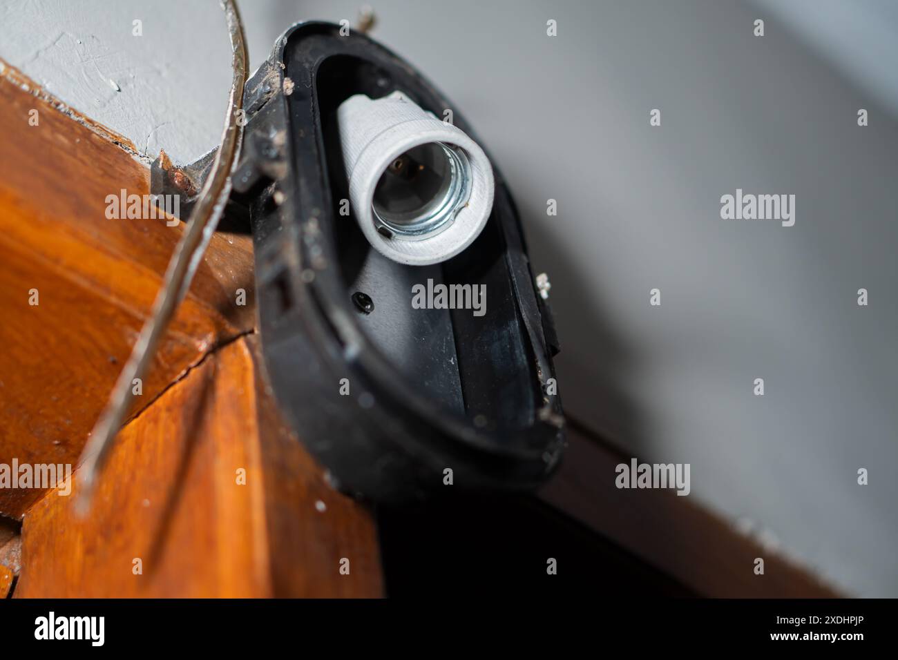 Close-up of an empty light bulb socket with visible wiring inside a ...