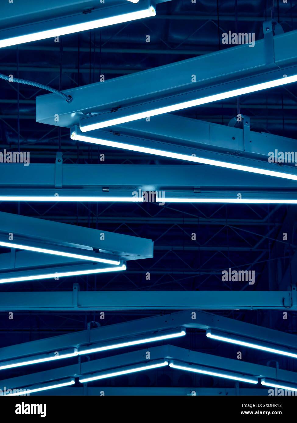 Ceiling with pipes is beautifully decorated with many industrial lamps ...