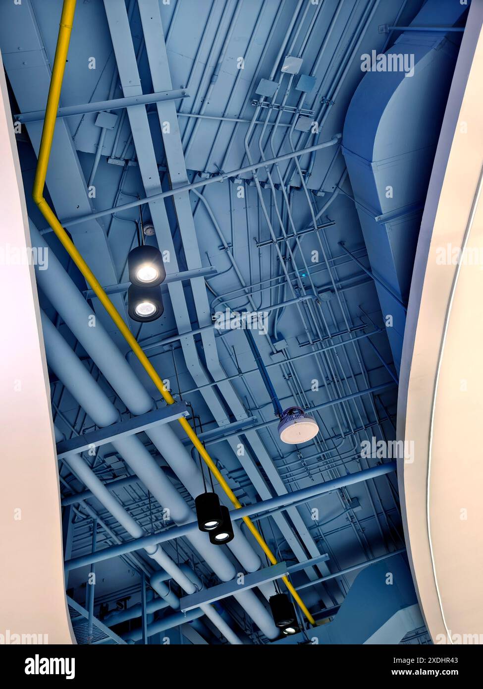 Ceiling with pipes and lights in creates industrial a pattern Stock ...
