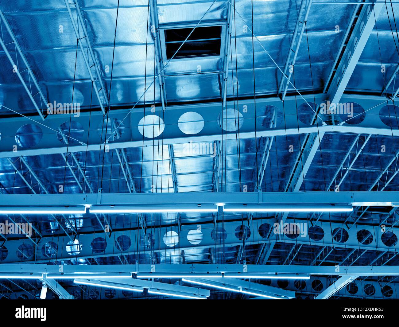 Ceiling with pipes is beautifully decorated with many industrial lamps ...