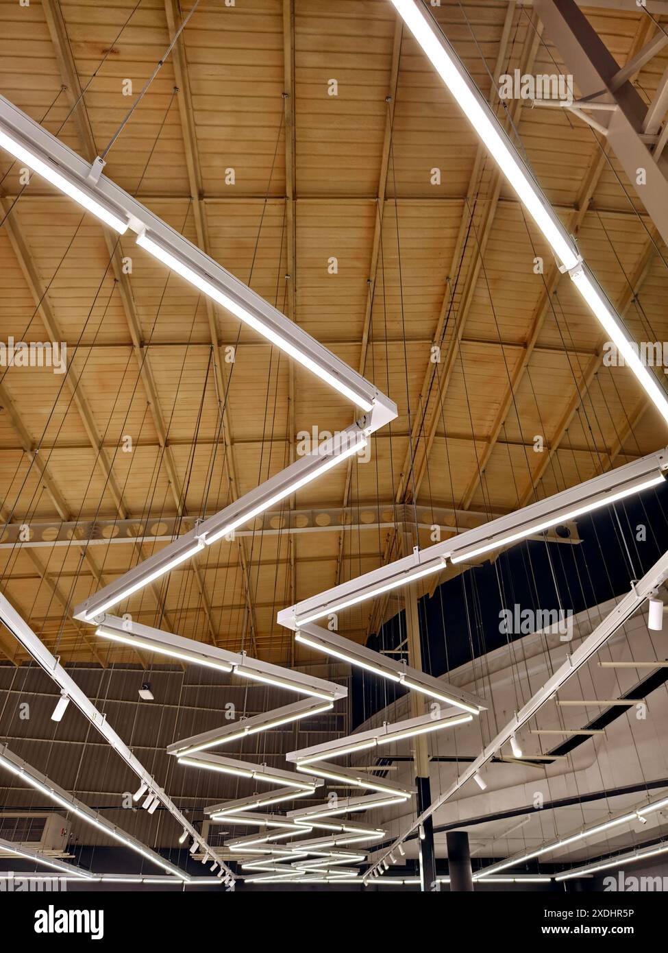 Ceiling with pipes is beautifully decorated with many industrial lamps ...