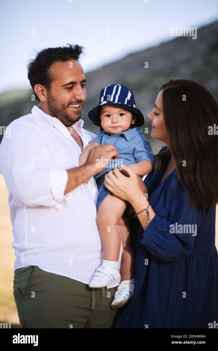 A family portrait in nature with a Turkish father, Uzbek mother, and ...