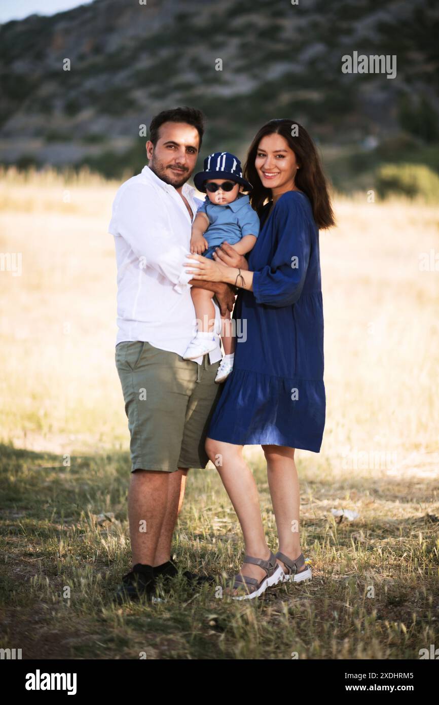 A family portrait in nature with a Turkish father, Uzbek mother, and ...