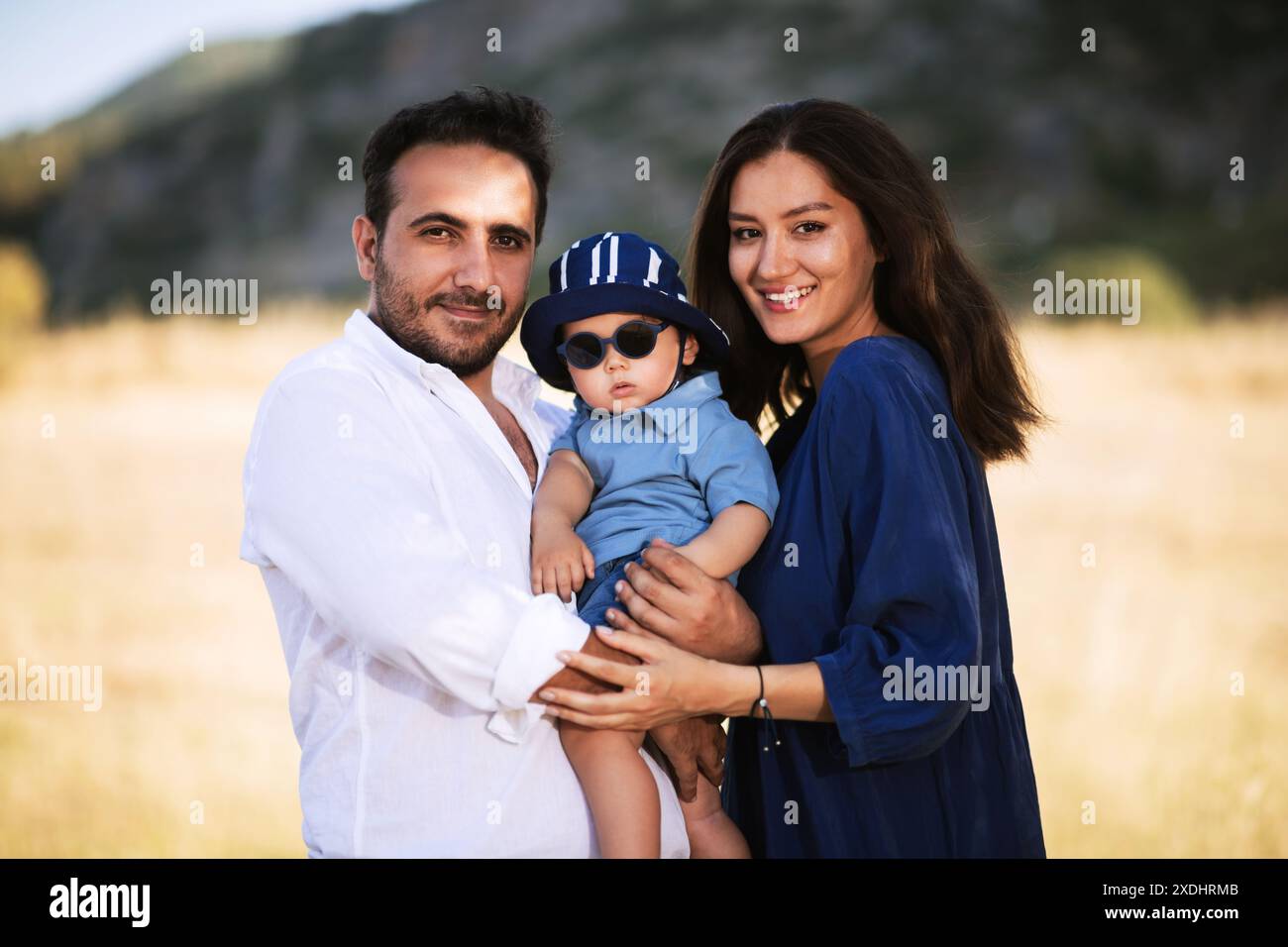 A family portrait in nature with a Turkish father, Uzbek mother, and ...