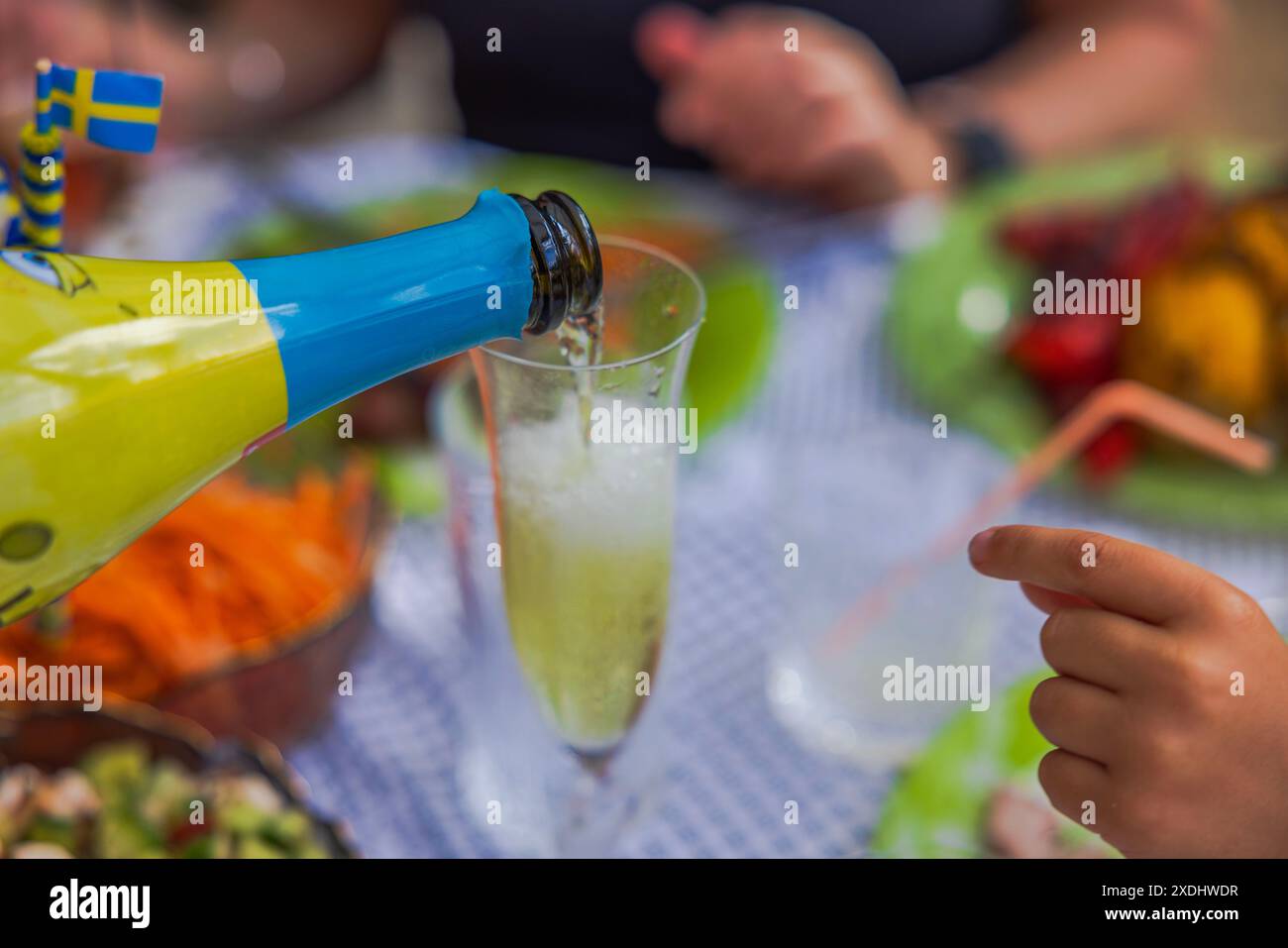Close-up view of pouring children's sparkling drink into champagne ...