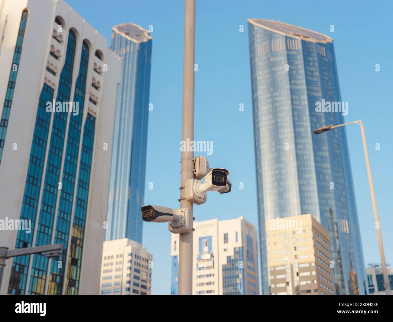 Digital modern cctv camera or security camera over blurred city skyline ...